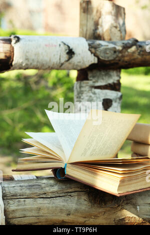 Stack of books on bench, outdoors Stock Photo - Alamy