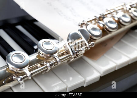 Flute and piano with music sheet close up Stock Photo - Alamy