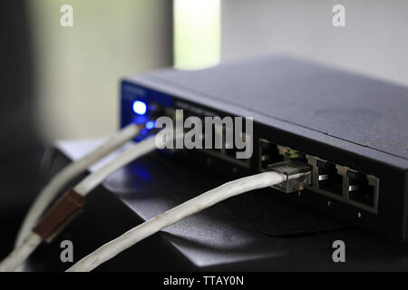 Closeup of fiber optic cable plugged into switch. Internet of things ...