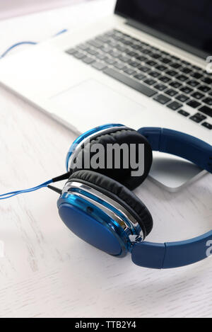 Headphones and other devices on wooden desktop in office Stock Photo ...