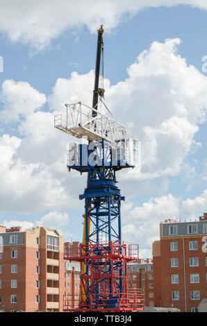 The assembly of the high crane. The crane lift raises part of the boom ...