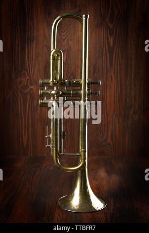 Silver trumpet on brown wooden background. Musical trumpet with ...