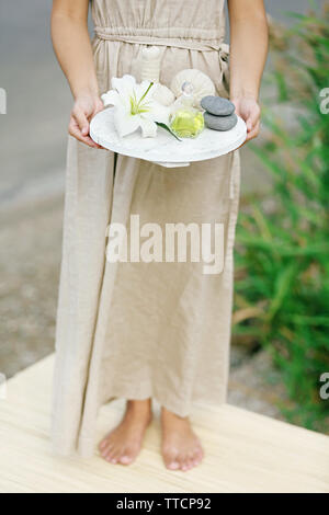 Female hands with tray of spa products, at spa salon Stock Photo - Alamy