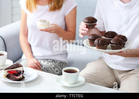 Friends hands with desserts and cups of tea, close up Stock Photo - Alamy