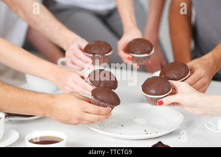 Friends hands with desserts and cups of tea, close up Stock Photo - Alamy