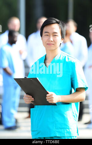 group of smiling medics at hospital with clipboard Stock Photo - Alamy