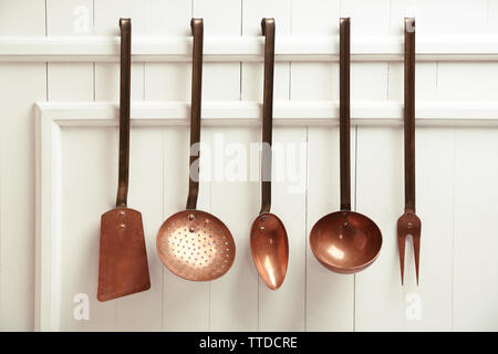 Kitchen utensil of scapula, spoons and fork on wooden background Stock ...