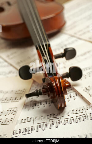 Violin neck on music papers background Stock Photo - Alamy