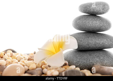 Few spa stones with plumeria on sand, isolated on white Stock Photo - Alamy