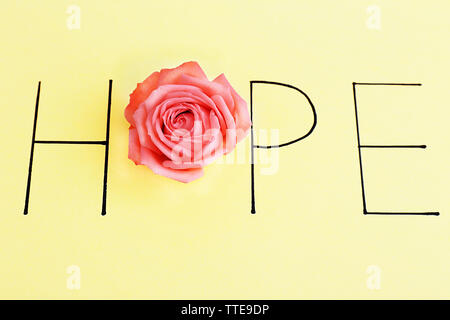 Inscription hope with pink rose on green background Stock Photo - Alamy