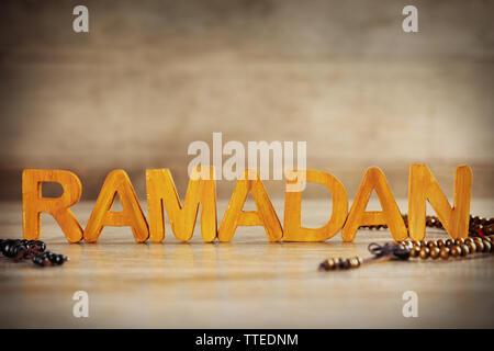 Ramadan word with wooden letters and rosary on table Stock Photo - Alamy