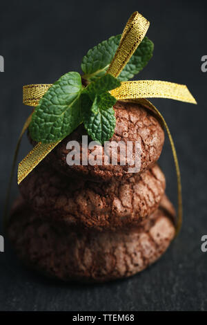 Chocolate chip cookie with yellow stripe and mint on dark background ...