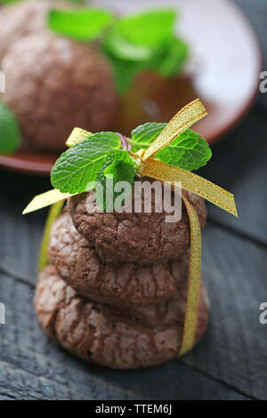 Chocolate chip cookie with yellow stripe and mint on wooden background ...