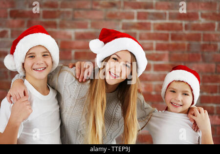 Happy cousins on brick wall background Stock Photo - Alamy
