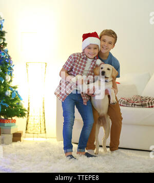 Dog in Christmas decorated background with Santa Claus hat looking at ...