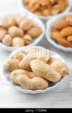 Pistachios, almonds, peanuts and walnut kernels in the wooden bowls on ...