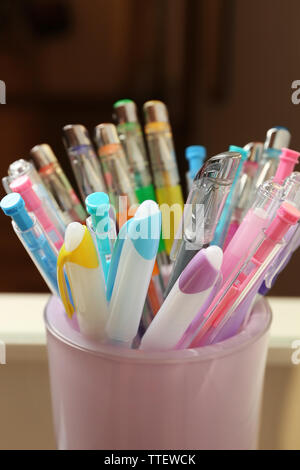 Close up of colorful gel pens arranged in rainbow palette order inside ...