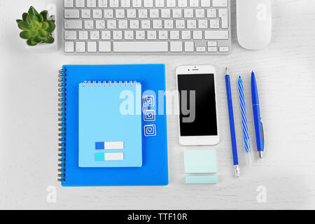 Workplace with mobile phone, computer peripherals and stationery on ...