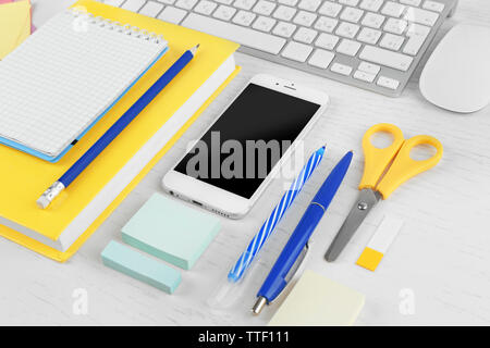 Workplace with mobile phone, computer peripherals and stationery on ...