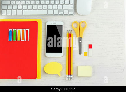 Workplace with mobile phone, computer peripherals and stationery on ...
