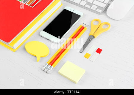 Workplace with mobile phone, computer peripherals and stationery on ...