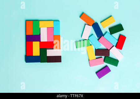 order and chaos. Chaotic unorganized colored dominoes and ordered ...