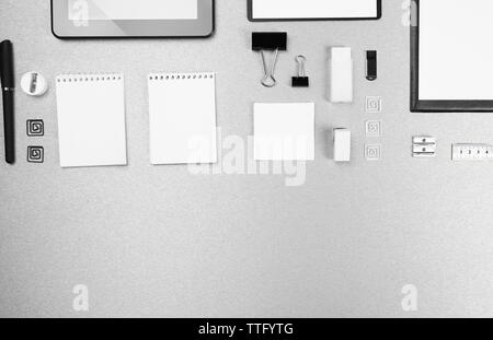 Office set with sheets of paper, tablet and stationery on light wooden ...