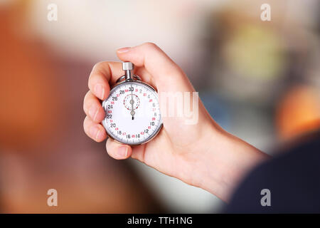 Woman holds stopwatch in hand, close up Stock Photo - Alamy