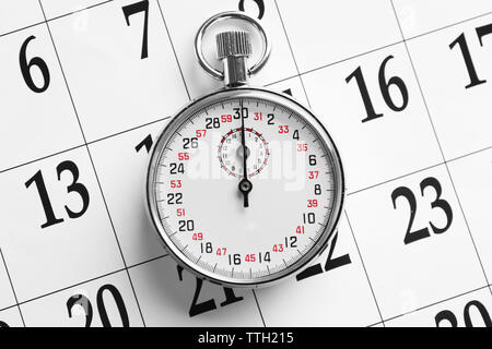 Stopwatch on calendar background, close up Stock Photo - Alamy