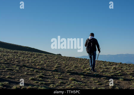 Young man taking an excursion on a mountain Stock Photo - Alamy