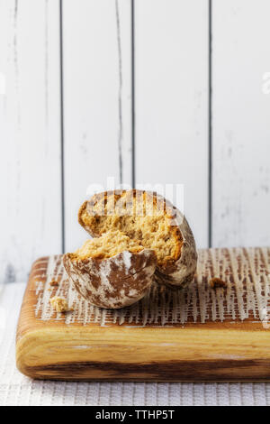 Broken fresh loaf bread on the board Stock Photo - Alamy