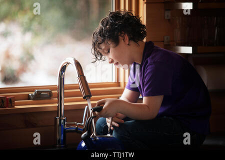 Filling a kettle in the kitchen Stock Photo - Alamy