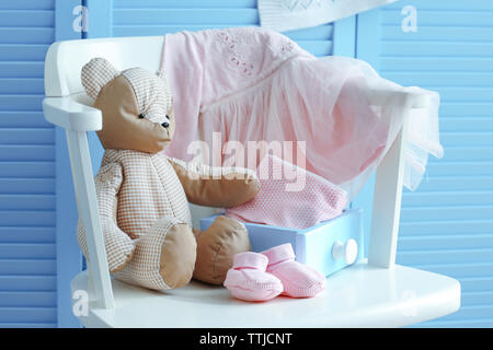 Baby toy on chair, door background Stock Photo - Alamy
