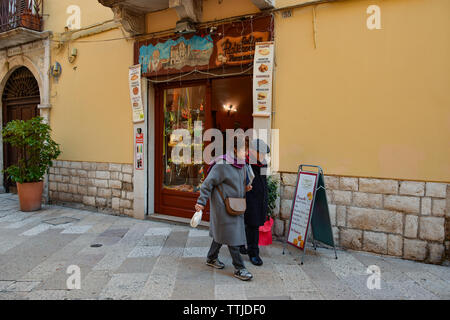 BARI, ITALY - FEBRUARY 9, 2019. Typical picturesque narrow street in ...