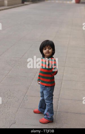 Back view of girl standing with raised hands in mountain village Stock ...