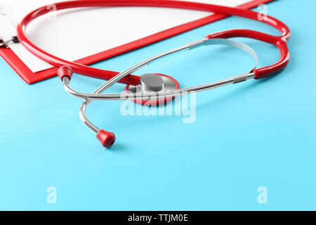 Red stethoscope with prescription on blue background Stock Photo - Alamy