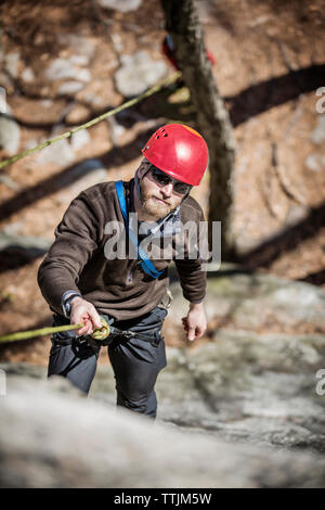 one man rappelling down Looking Glass Arch Stock Photo - Alamy