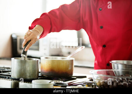 Midsection of woman stirring chocolate Stock Photo - Alamy