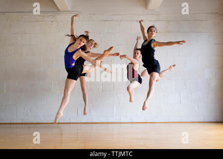 Group of young dancers jumping together in class Stock Photo - Alamy