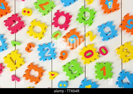 Colorful puzzle mat on wooden background Stock Photo - Alamy