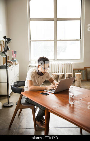 serious adult businessman wearing headphones having a video call to the ...