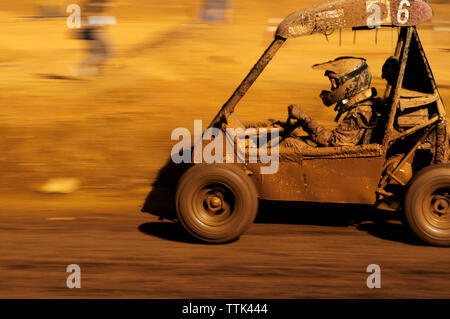 man riding a beach buggy at speed with a power kite on saltburn beach ...