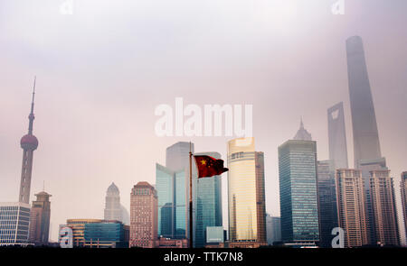 Oriental Pearl Tower against a clear blue sky with scattered clouds ...