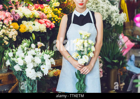 Midsection of florist holding roses in shop Stock Photo - Alamy