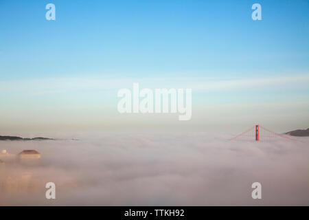 Clouds covering Golden Gate Bridge against blue sky Stock Photo - Alamy