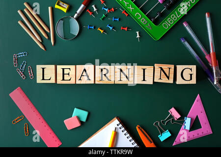 Colourful stationery and word LEARNING on chalkboard Stock Photo - Alamy