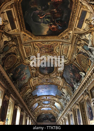 Low-angle view of Louvre Palace against clear blue sky seen through ...
