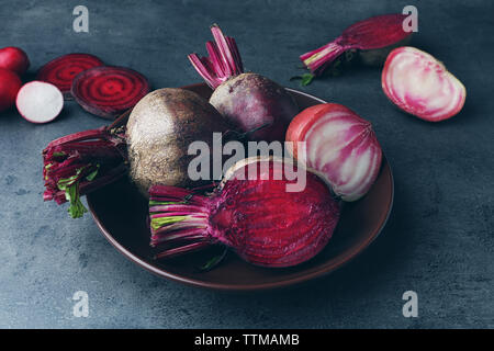 Beet slices with radishes on grey table Stock Photo - Alamy