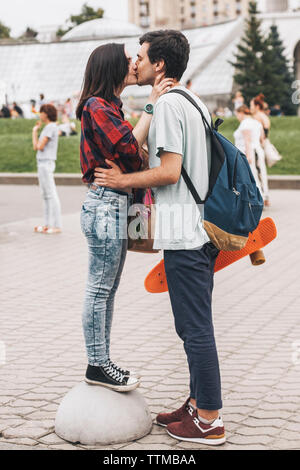 Side view of a loving couple kissing Stock Photo - Alamy
