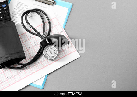 Tonometer with calculator and cardiogram on table Stock Photo - Alamy